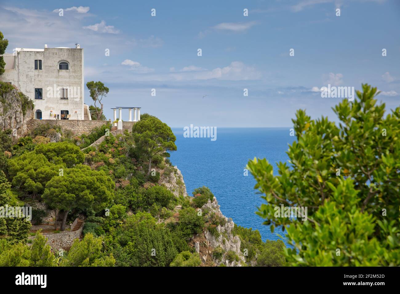 Traditional italian house situated on a cliff. Landscape view with ...