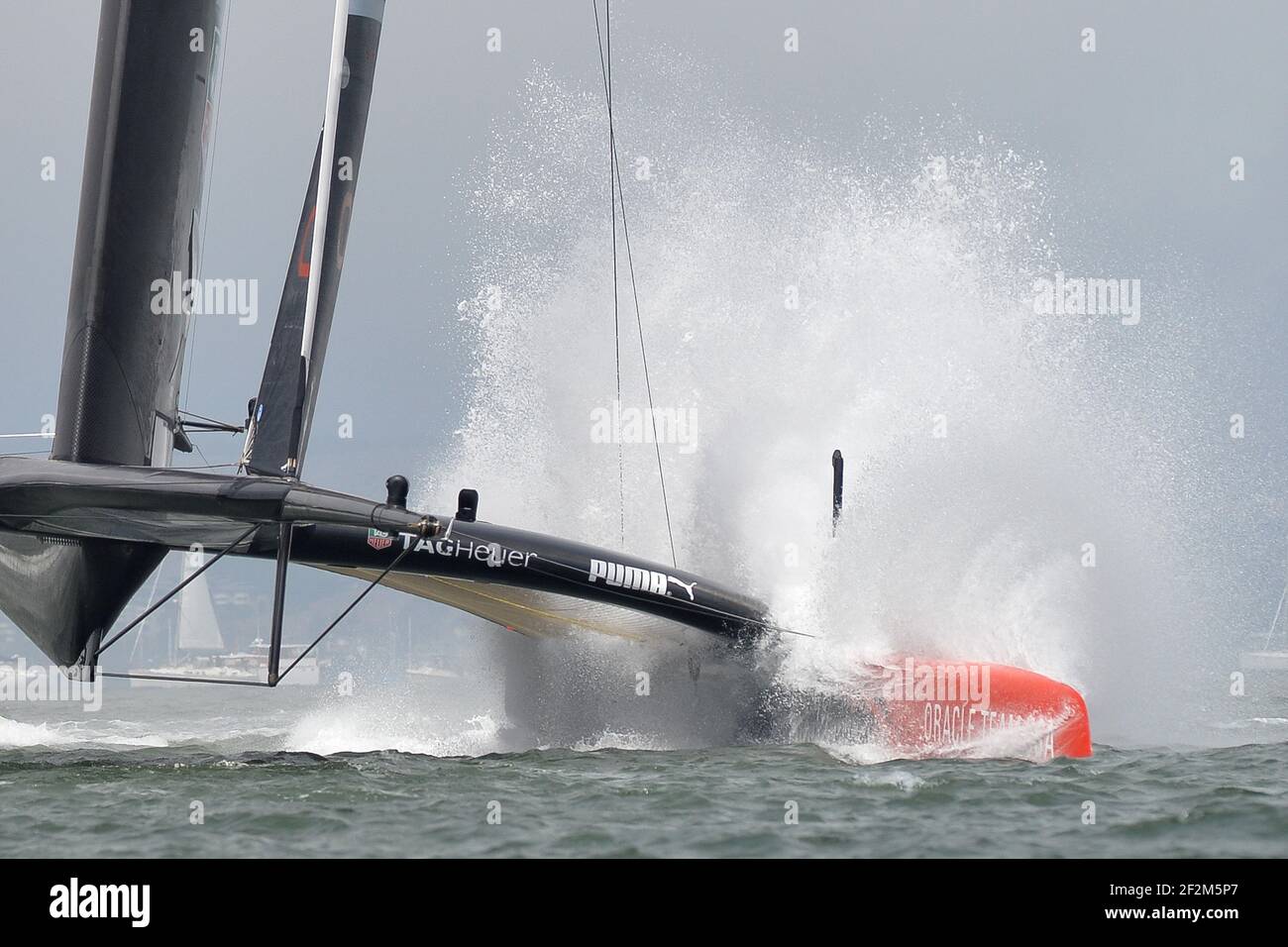 Water splashing from left wing of Defender Oracle Team USA in action ...