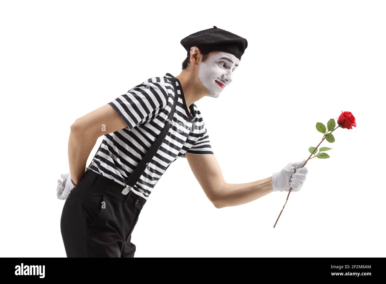 Mime giving a red rose isolated on white background Stock Photo - Alamy