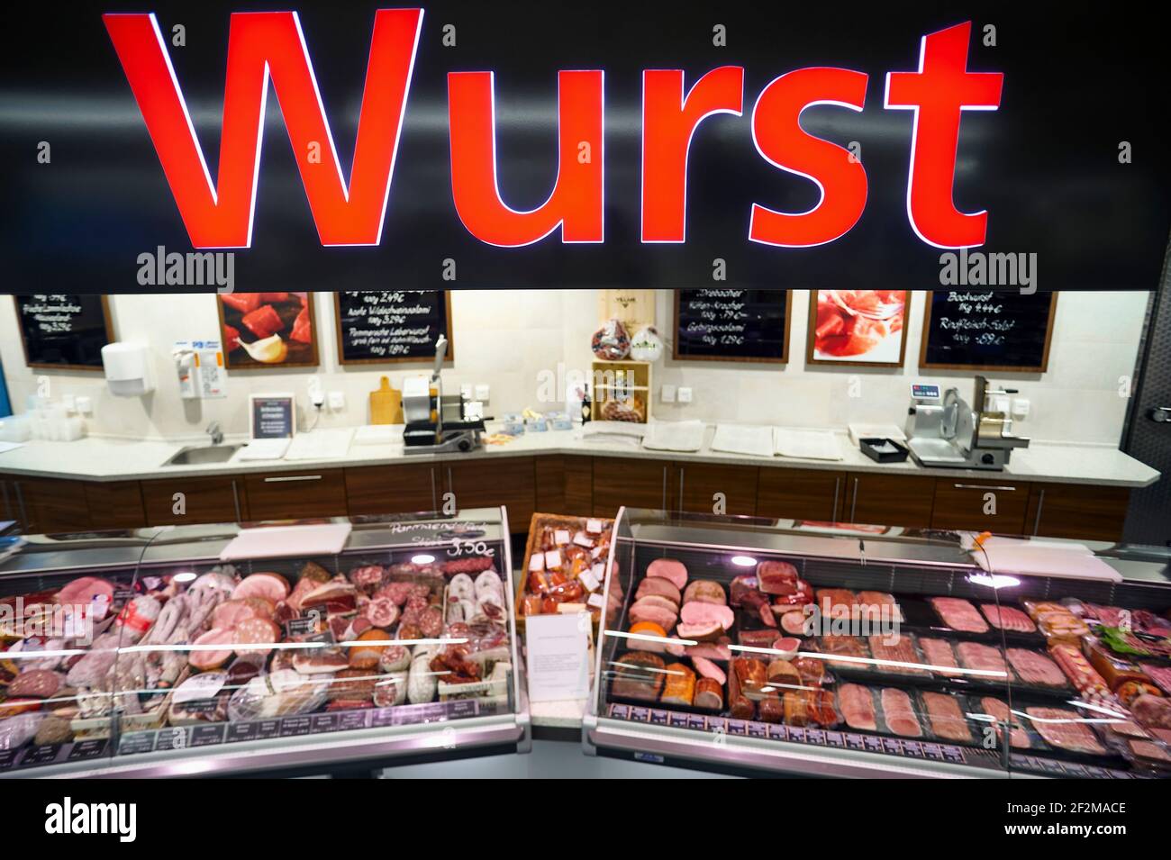 Meat counter from above with a large display with sausage in the ...