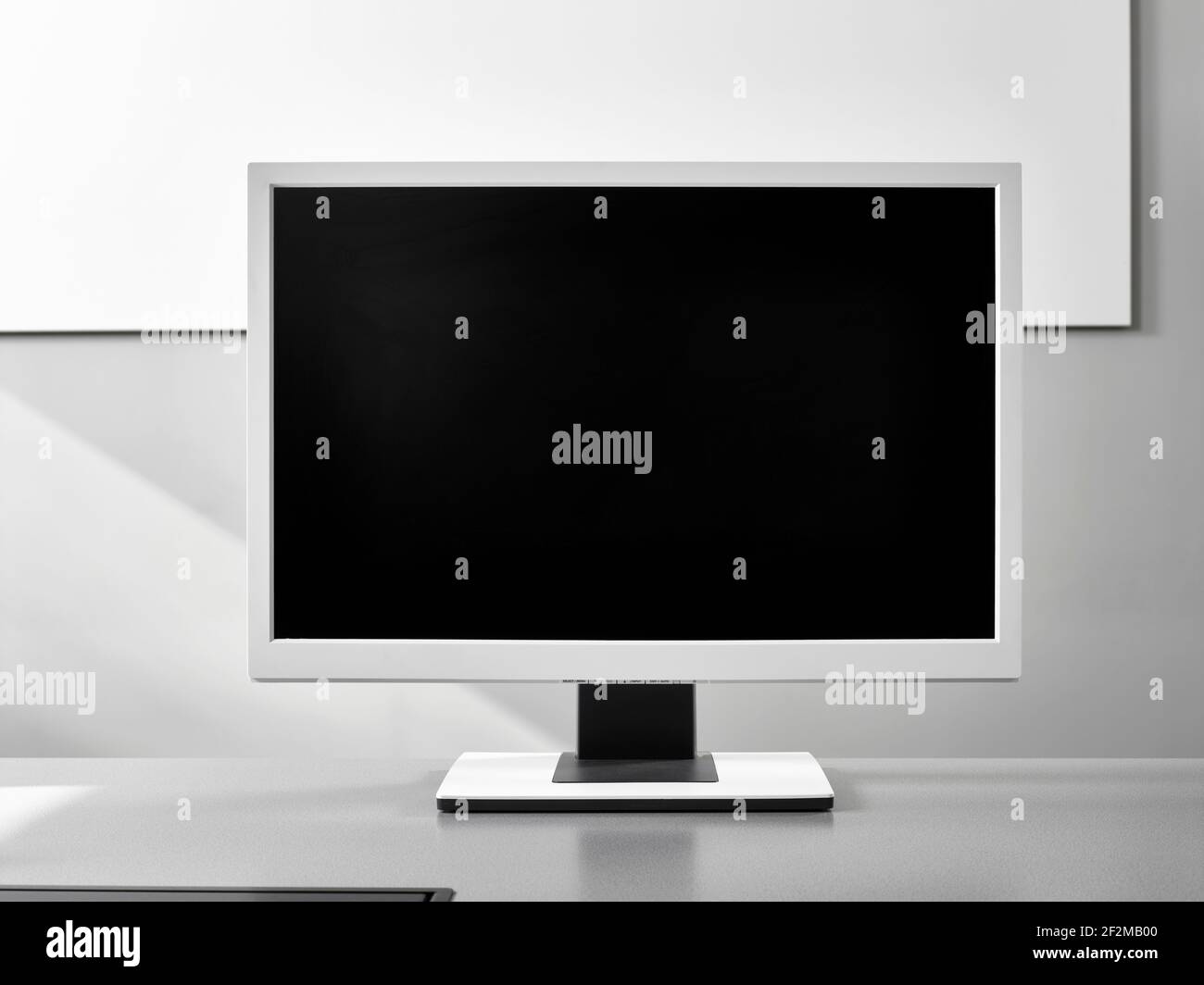 Switched off monitor in front of a white and gray conference room ...