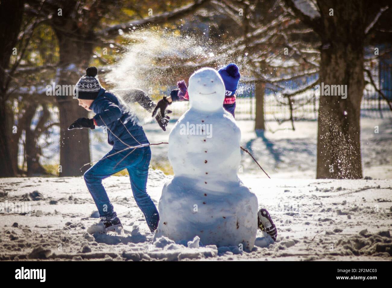 Happy kids playing snowball fight hi-res stock photography and images ...