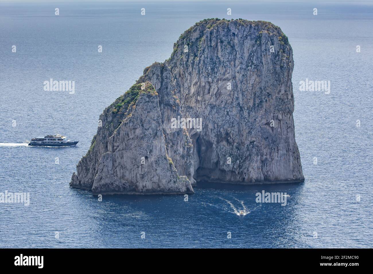 Excursion boats at the Faraglioni Rocks. View of the famous Faraglioni ...