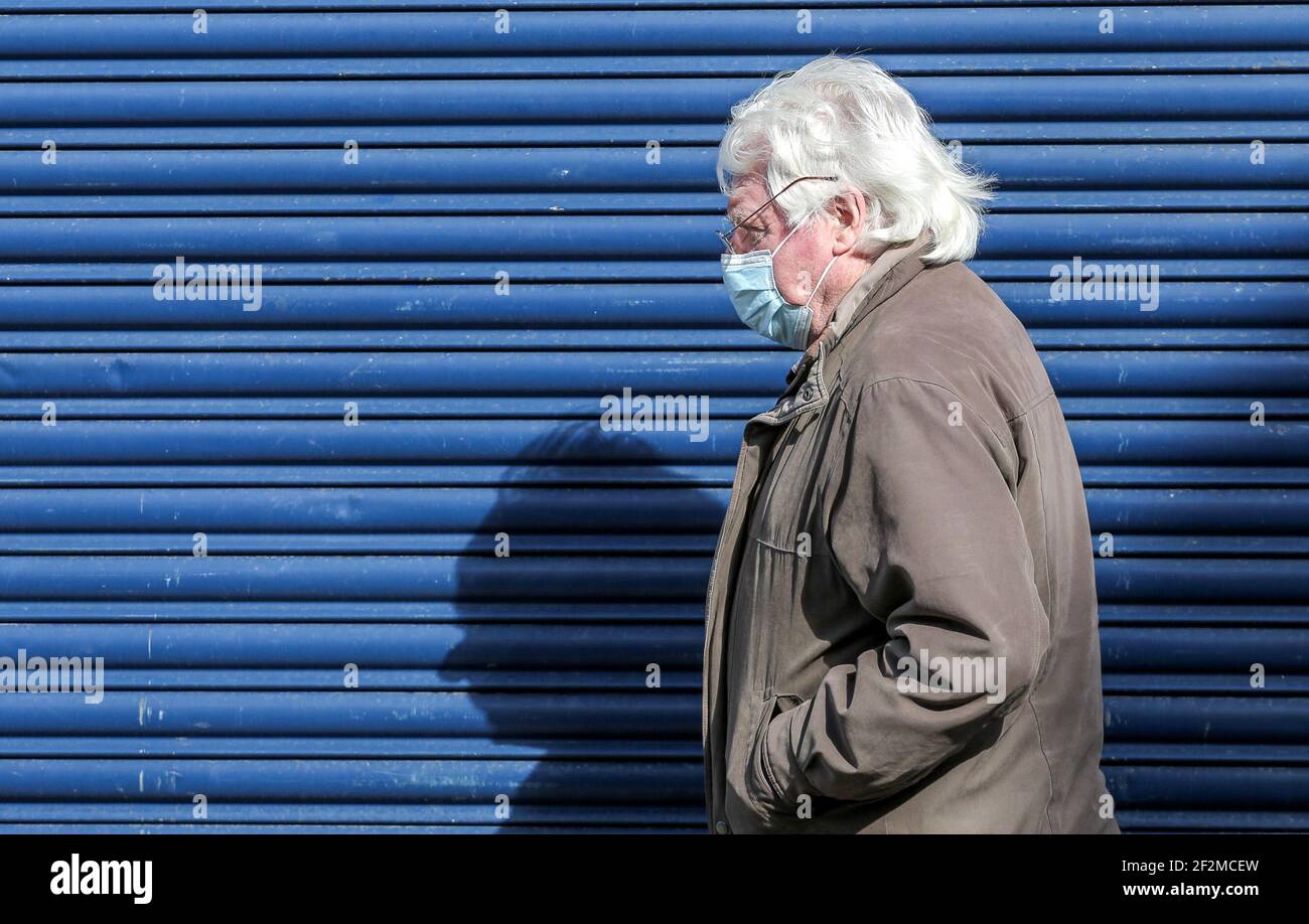 12th, March, 2021. Cheltenham, England. A member of the public walks ...