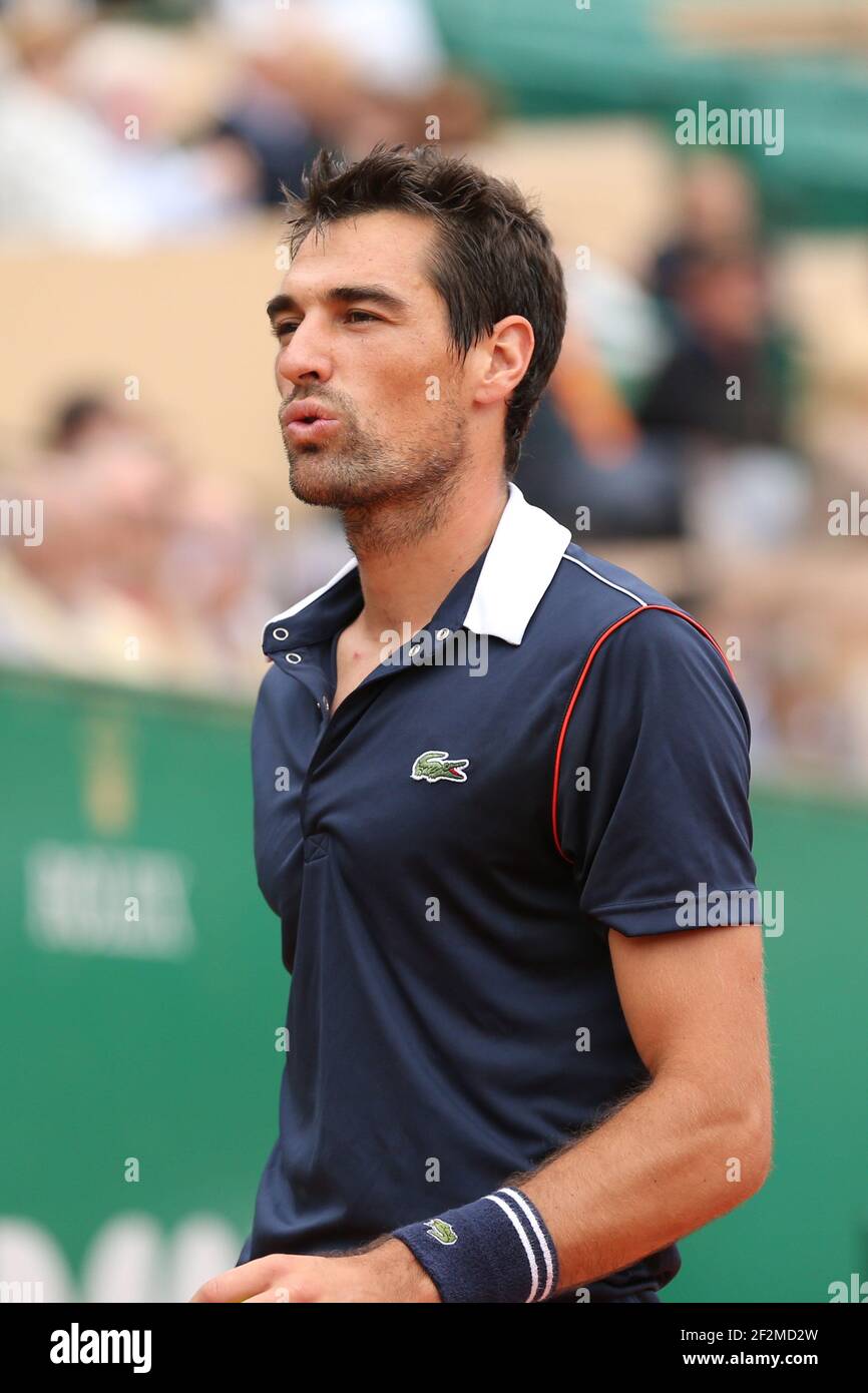 Jeremy Chardy of France in action against Roger Federer of Switzerland ...