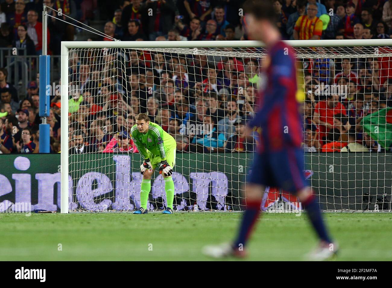 Manuel Neuer of FC Bayern Munich looks dejected as Lionel Messi walk by ...