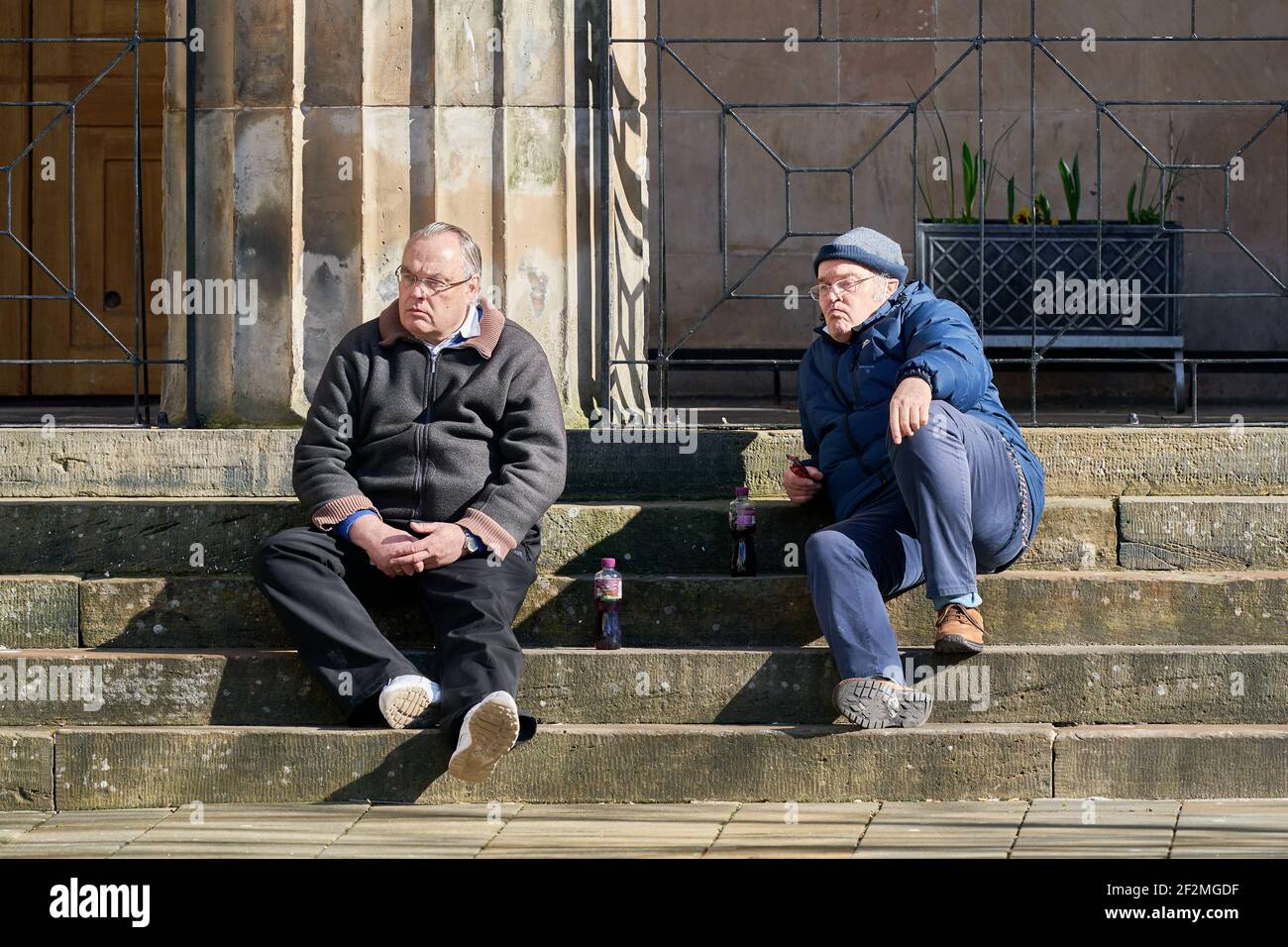 Elgin High Street, Moray, UK. 12th Mar, 2021. UK. This is 2 men sitting ...