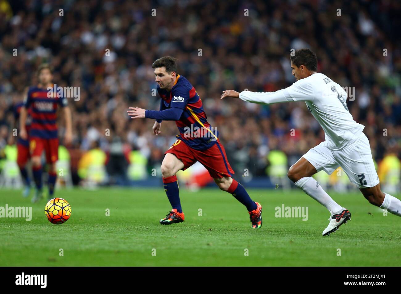 Lionel Messi FC Barcelona evades Raphael Varane of Real Madrid during ...