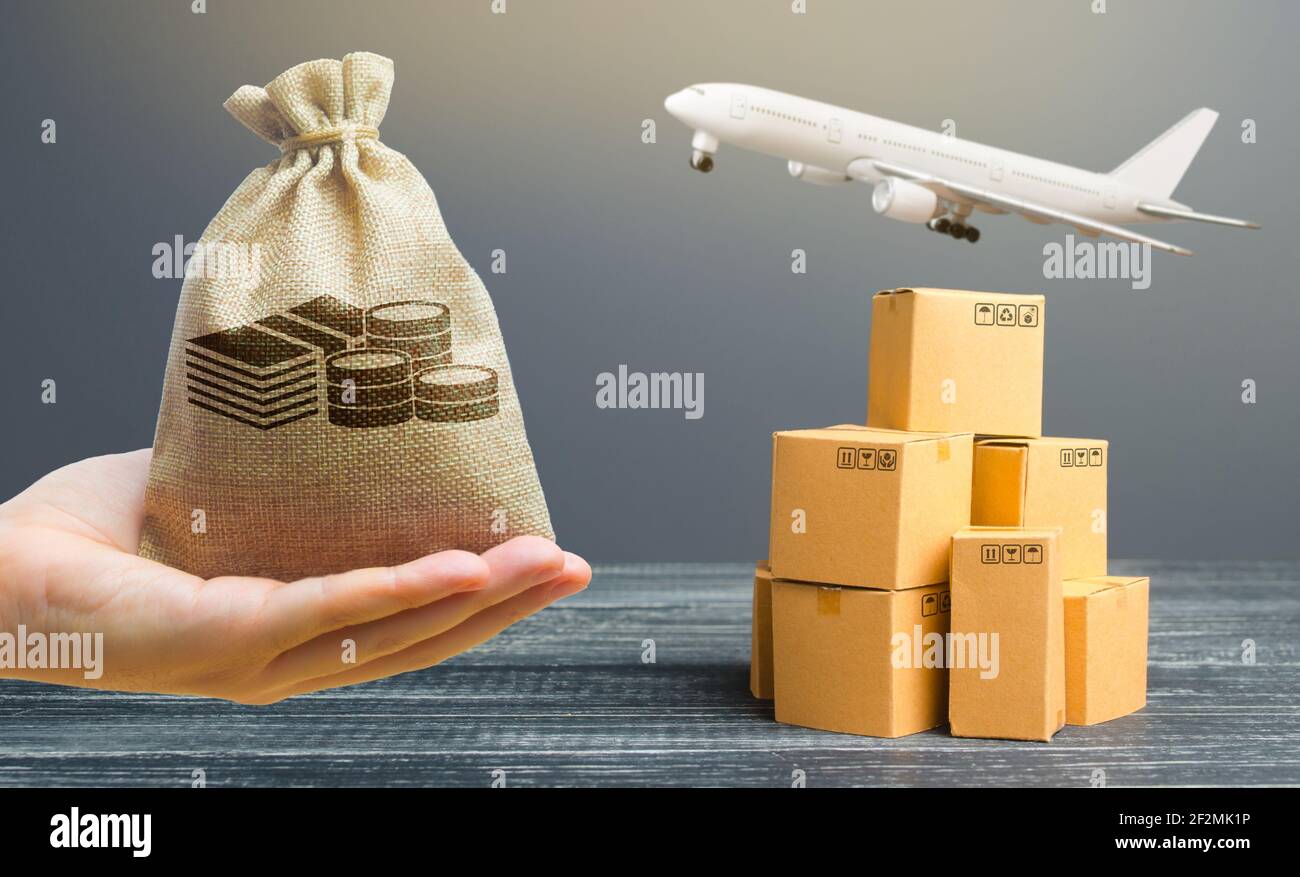 Money bag, cardboard boxes and freight airplane. International delivery ...