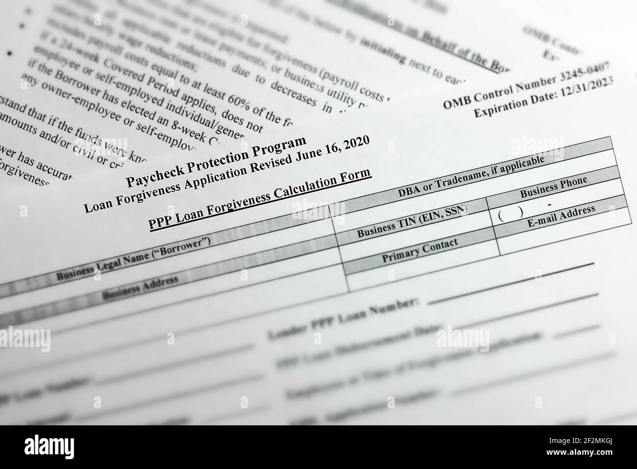 selective focus photo of paycheck protection program loan forgiveness application form revised ...