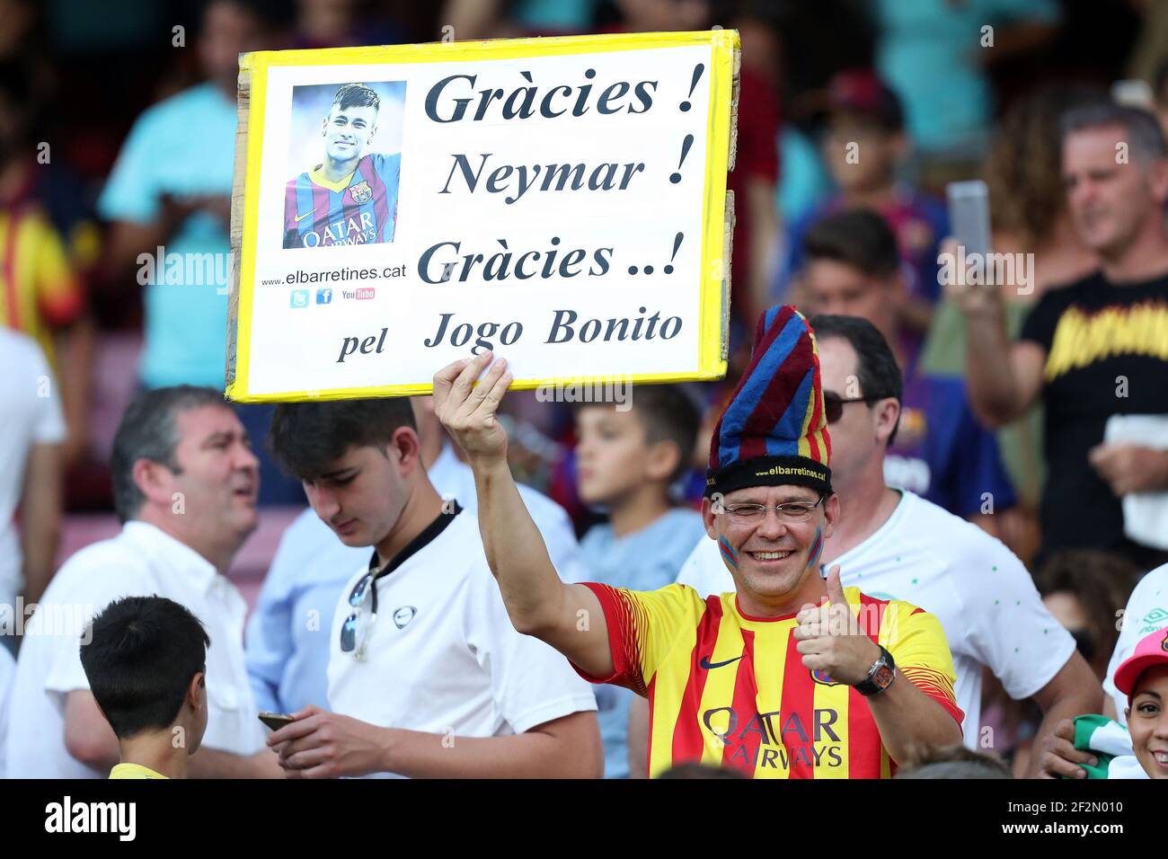 A Supporter of FC Barcelona holds a placard reading "Thank You Neymar ...