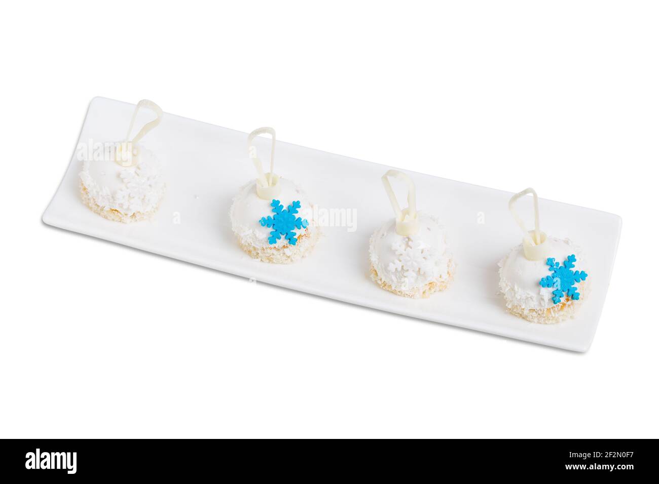Delicious glazed cakes with coconut frosting and blue mastic snowflakes ...