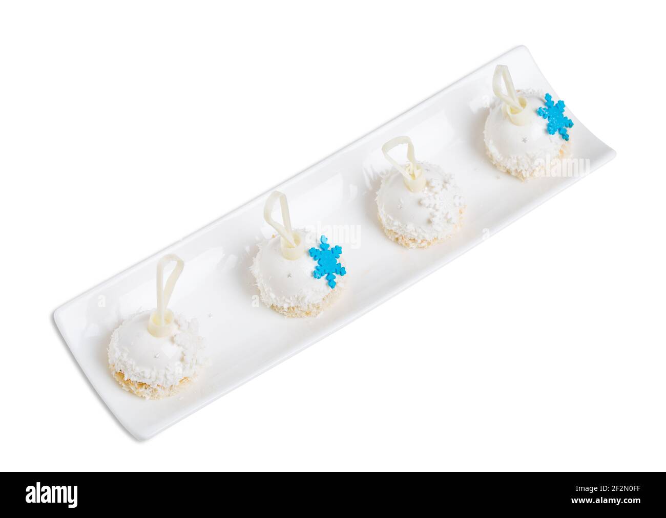 Delicious glazed cakes with coconut frosting and blue mastic snowflakes ...