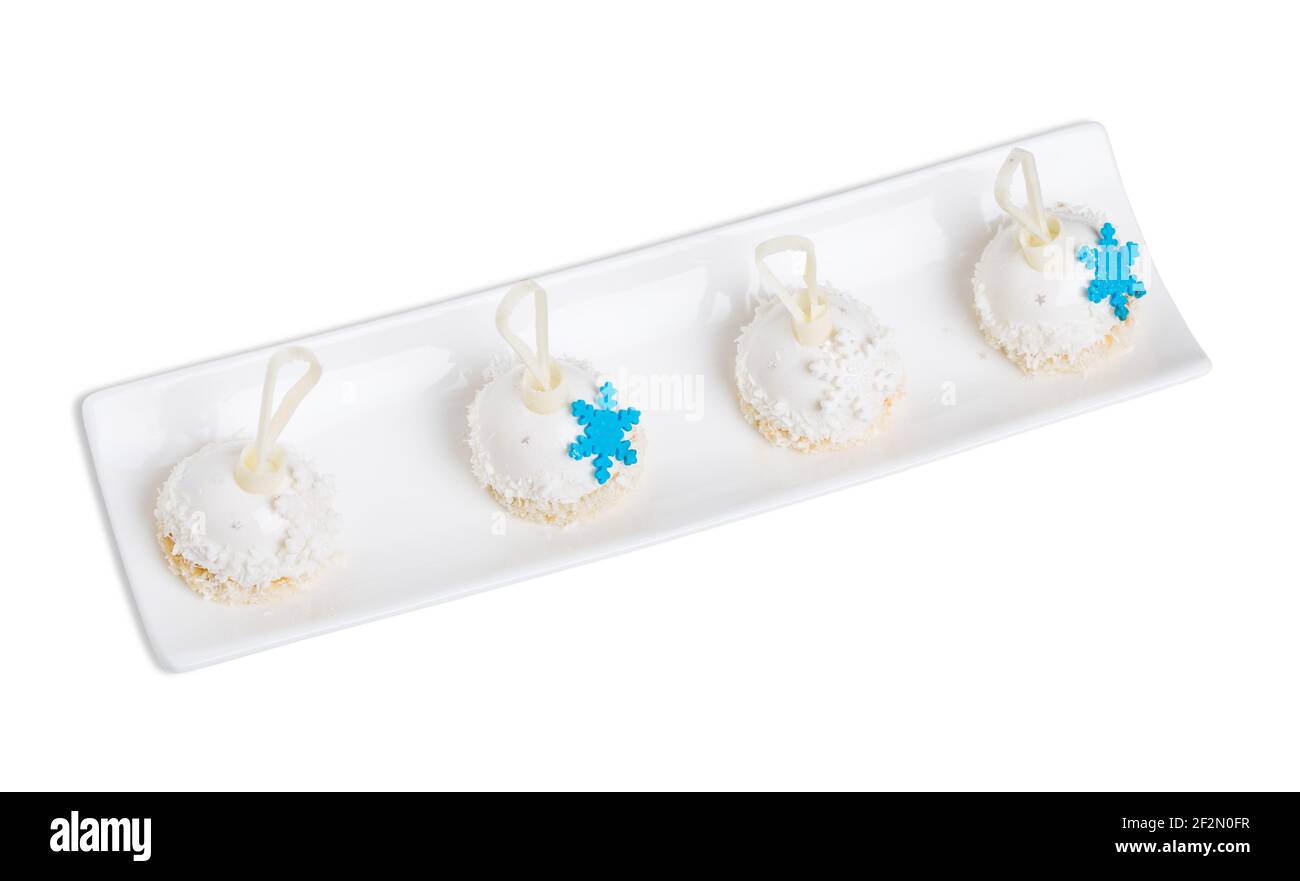 Delicious glazed cakes with coconut frosting and blue mastic snowflakes ...