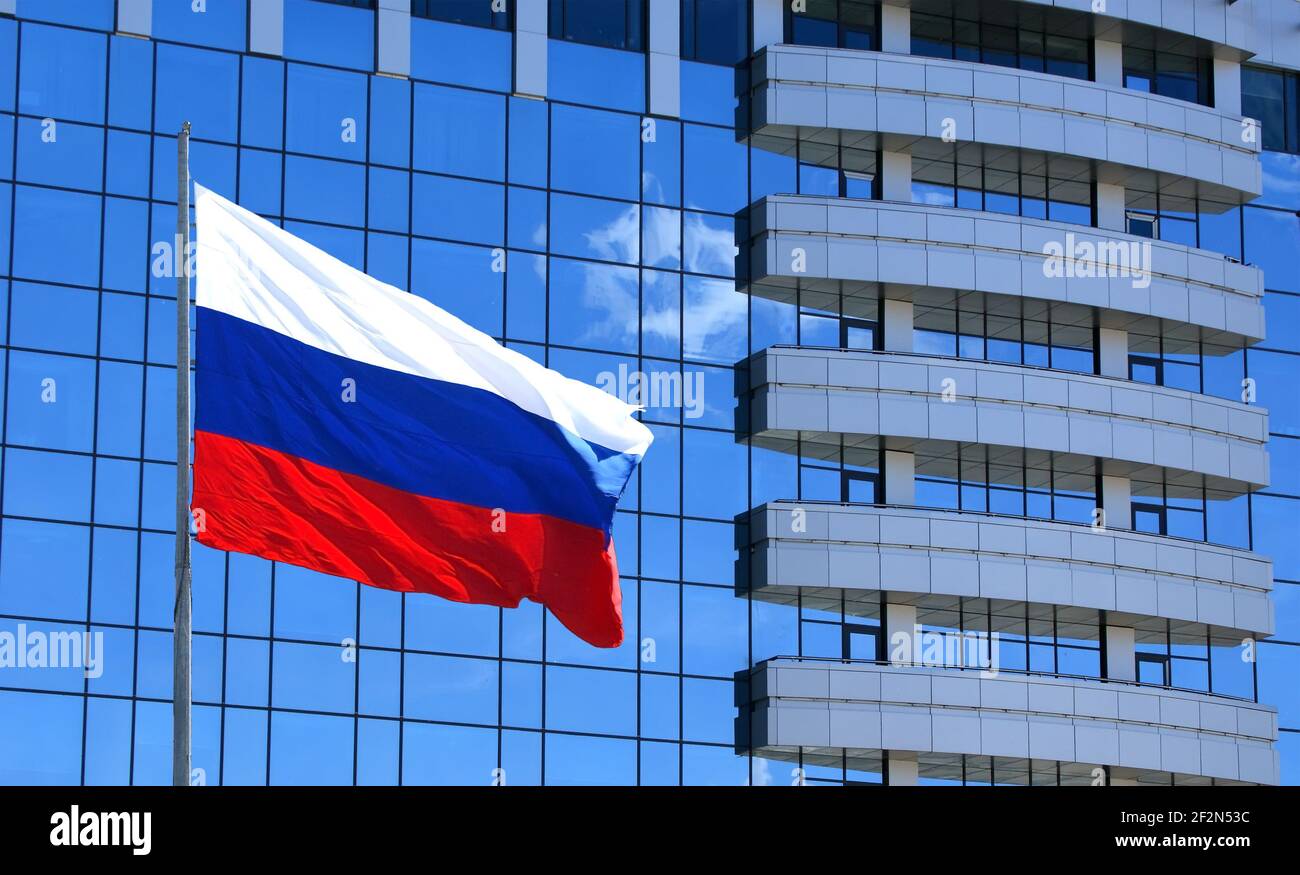 Russian flag on the background of the windows of office building Stock ...