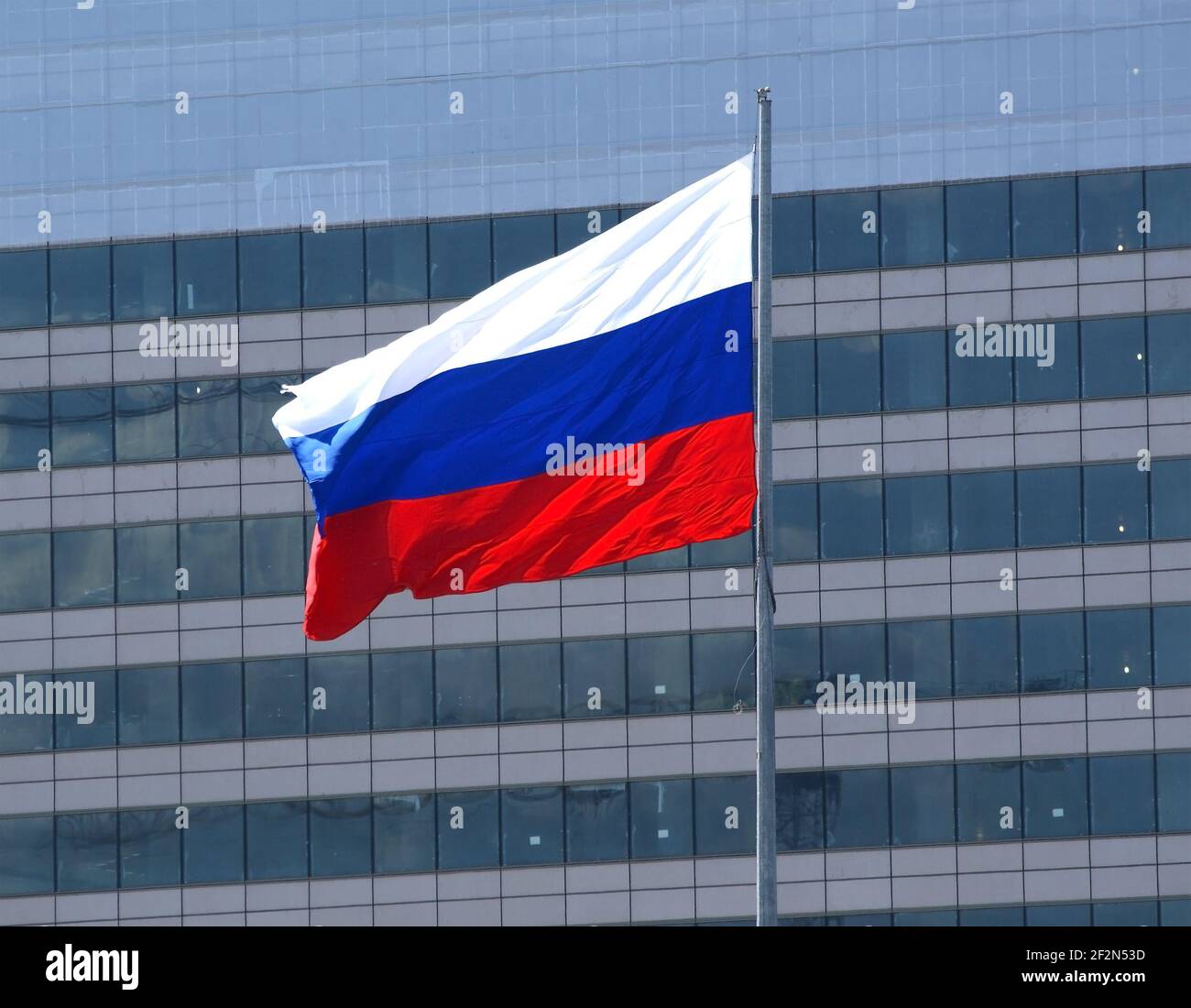 Russian flag on the background of the windows of office building Stock ...