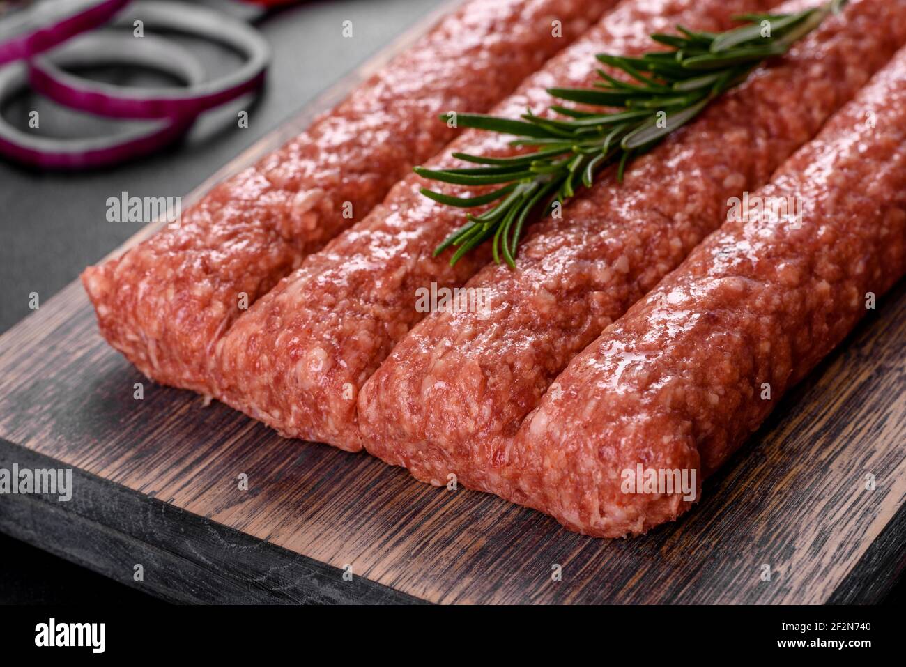 Fresh raw mince for grilled kebab with spices and herbs on a dark ...