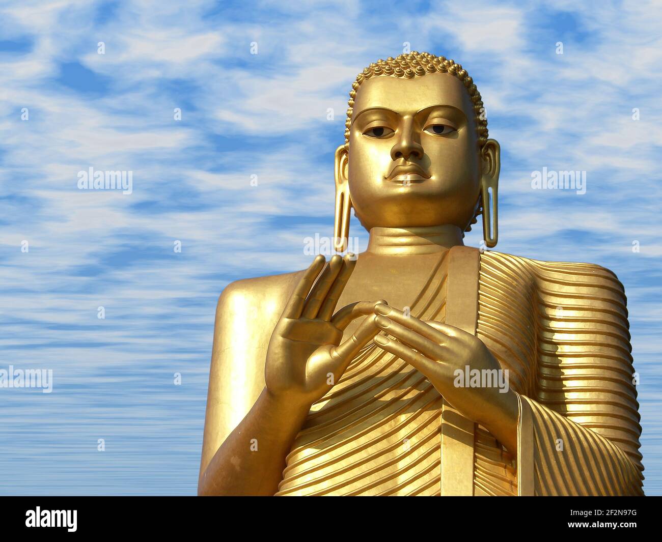 A large sculpture of a Buddha bright yellow color of gold, Sri Lanka ...