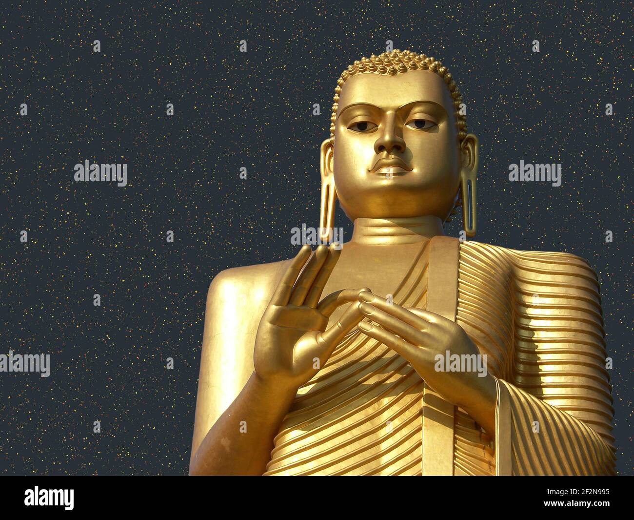 A large sculpture of a Buddha bright yellow color of gold, Sri Lanka ...