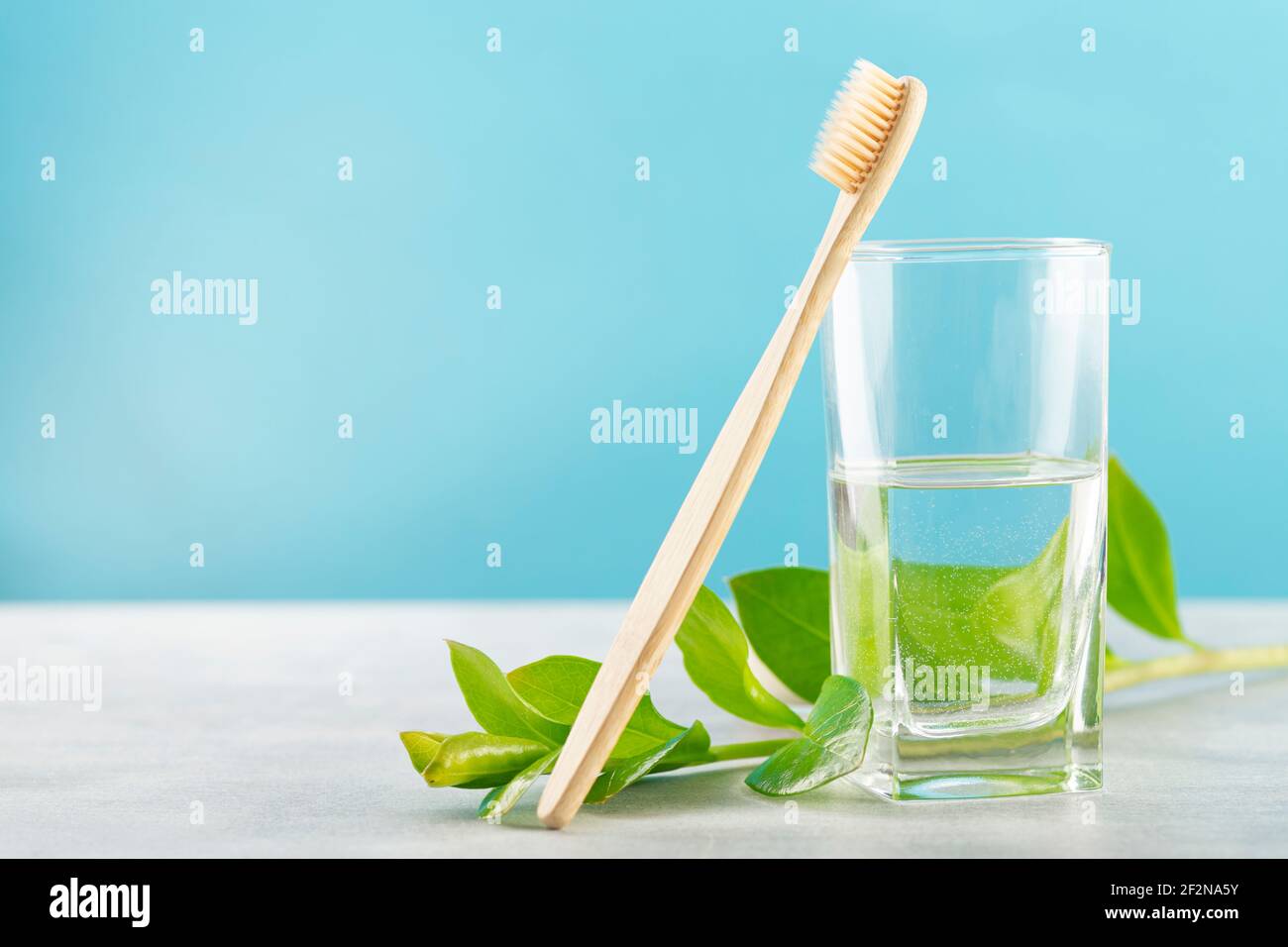 Ecological toothbrush made from natural bamboo, a glass of water and a ...