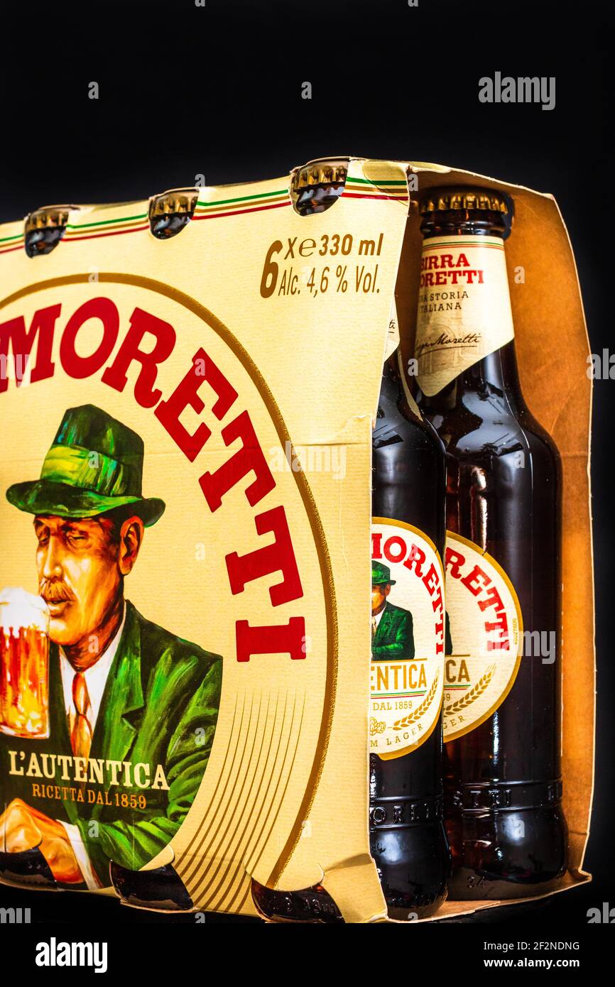 6 pack of Birra Moretti beer on wooden barrel with dark background ...