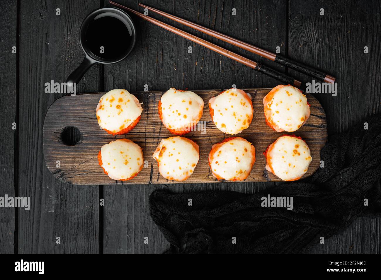 Baked sushi roll with shrimp and masago caviar cap. Traditional sushi ...