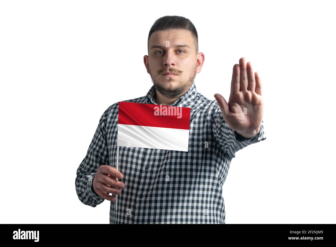 White guy holding a flag of Monaco and with a serious face shows a hand ...