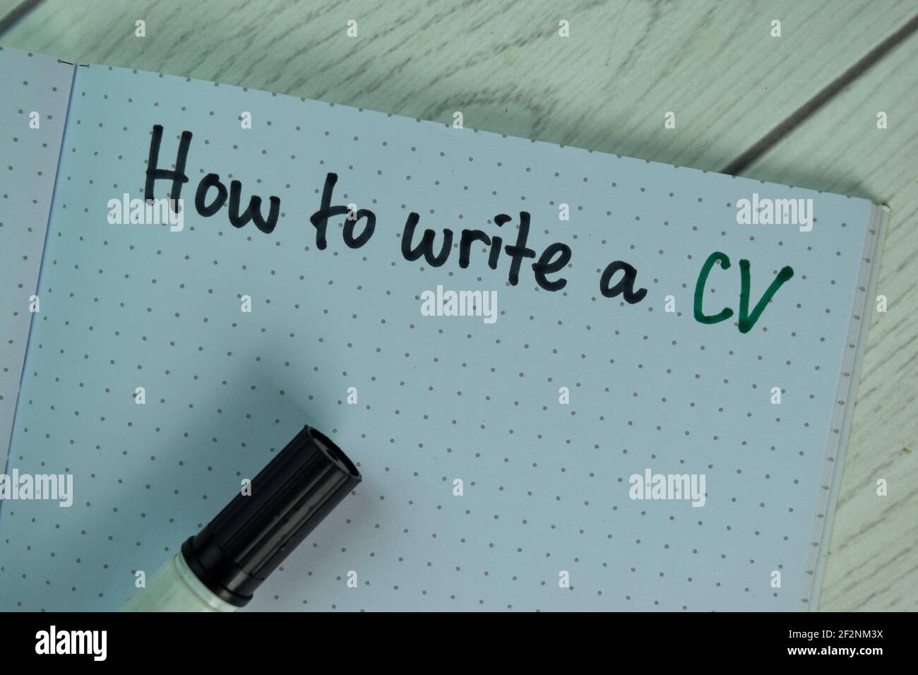 How to Write a CV write on a book isolated on Wooden Table Stock Photo ...