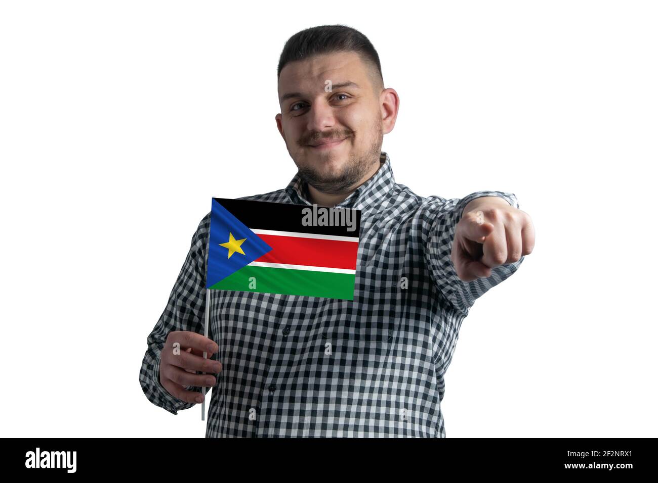 White guy holding a flag of South Sudan and points forward in front of ...