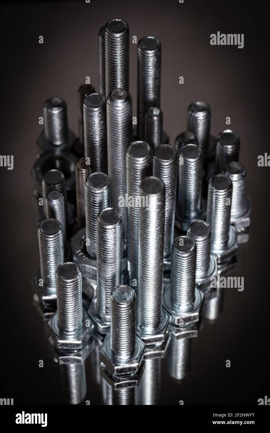 Bolts and nuts on a mirror background Stock Photo - Alamy