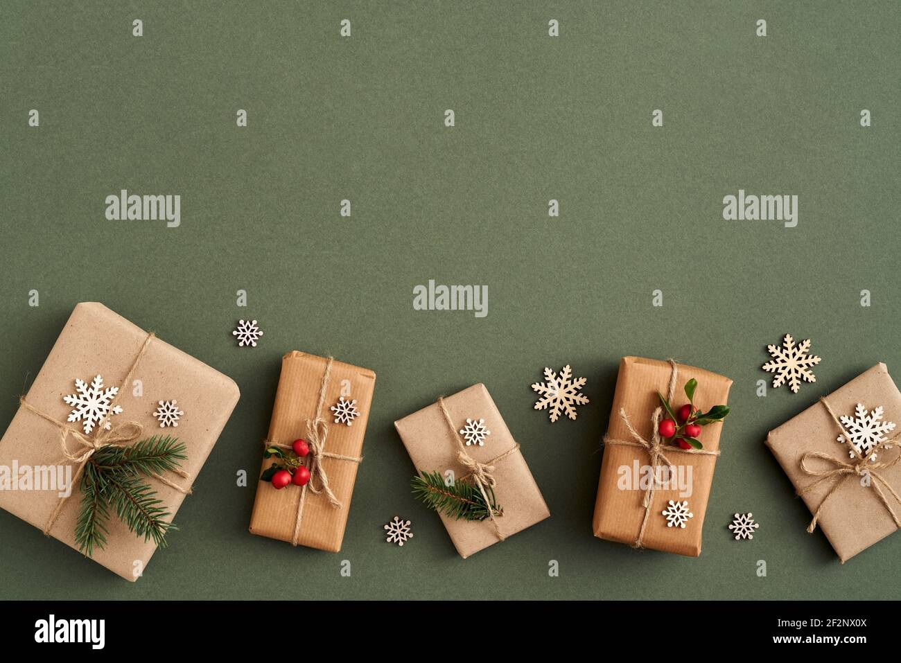 Christmas presents wrapped in ecological recycled paper with wooden ...
