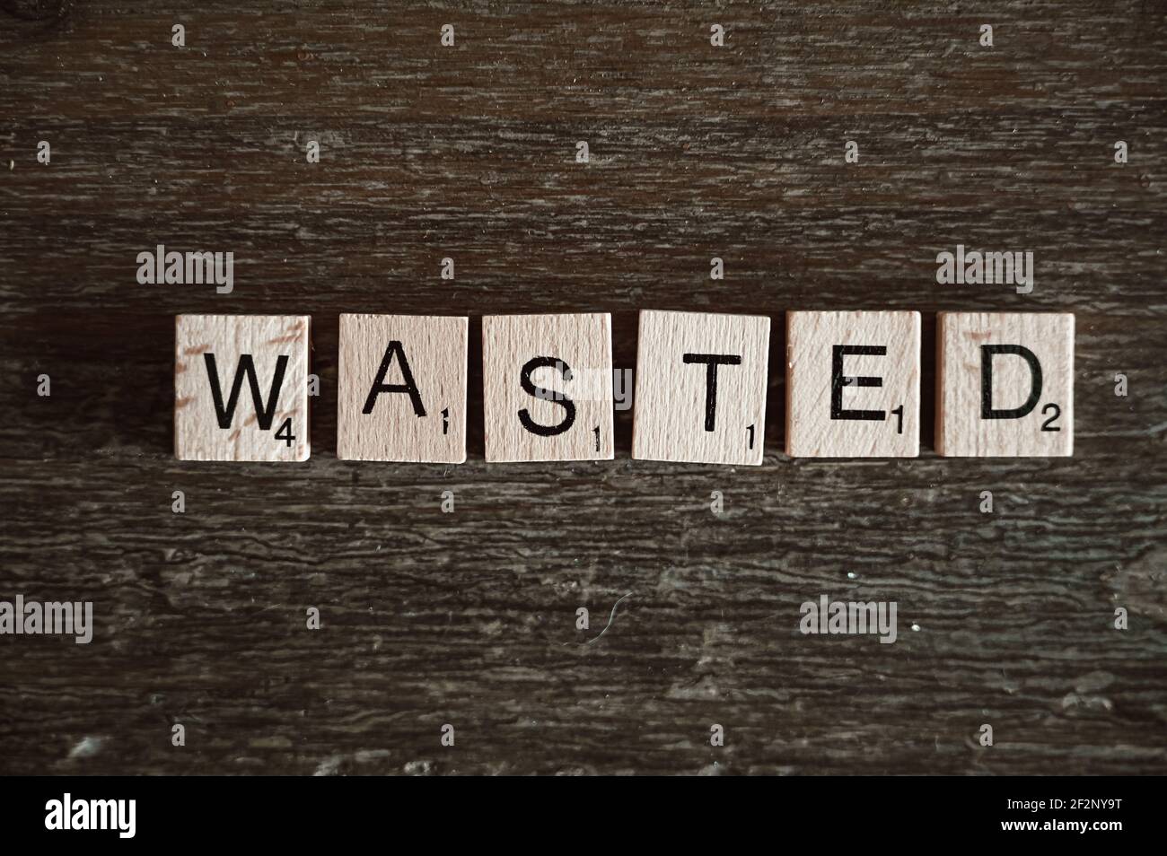 A word with brown wooden letters on a dark background Stock Photo - Alamy