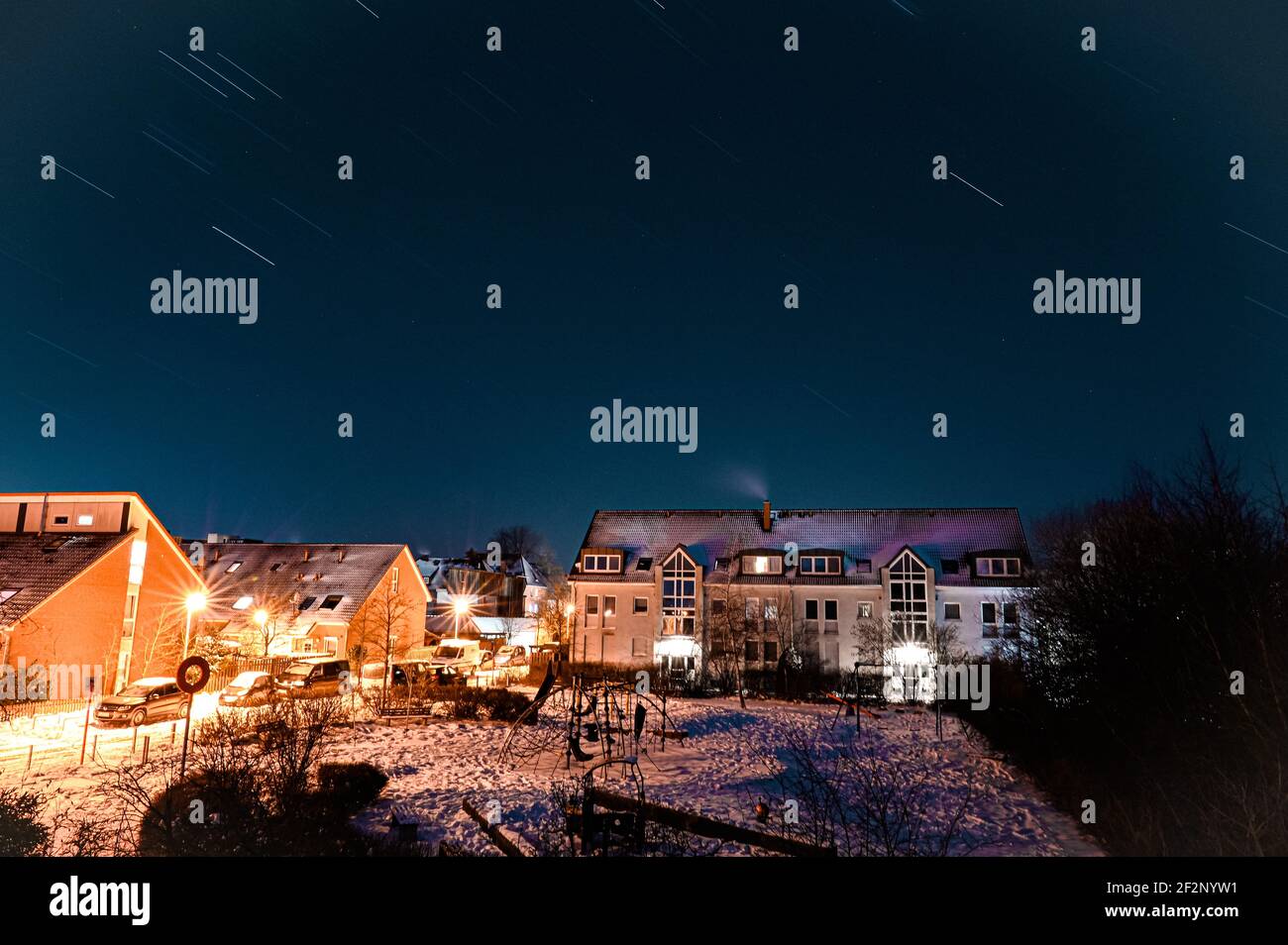 Apartment building at night in winter with snow Stock Photo - Alamy