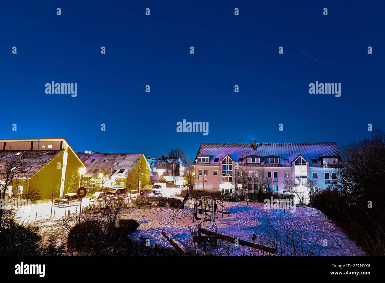 Apartment building at night in winter with snow Stock Photo - Alamy