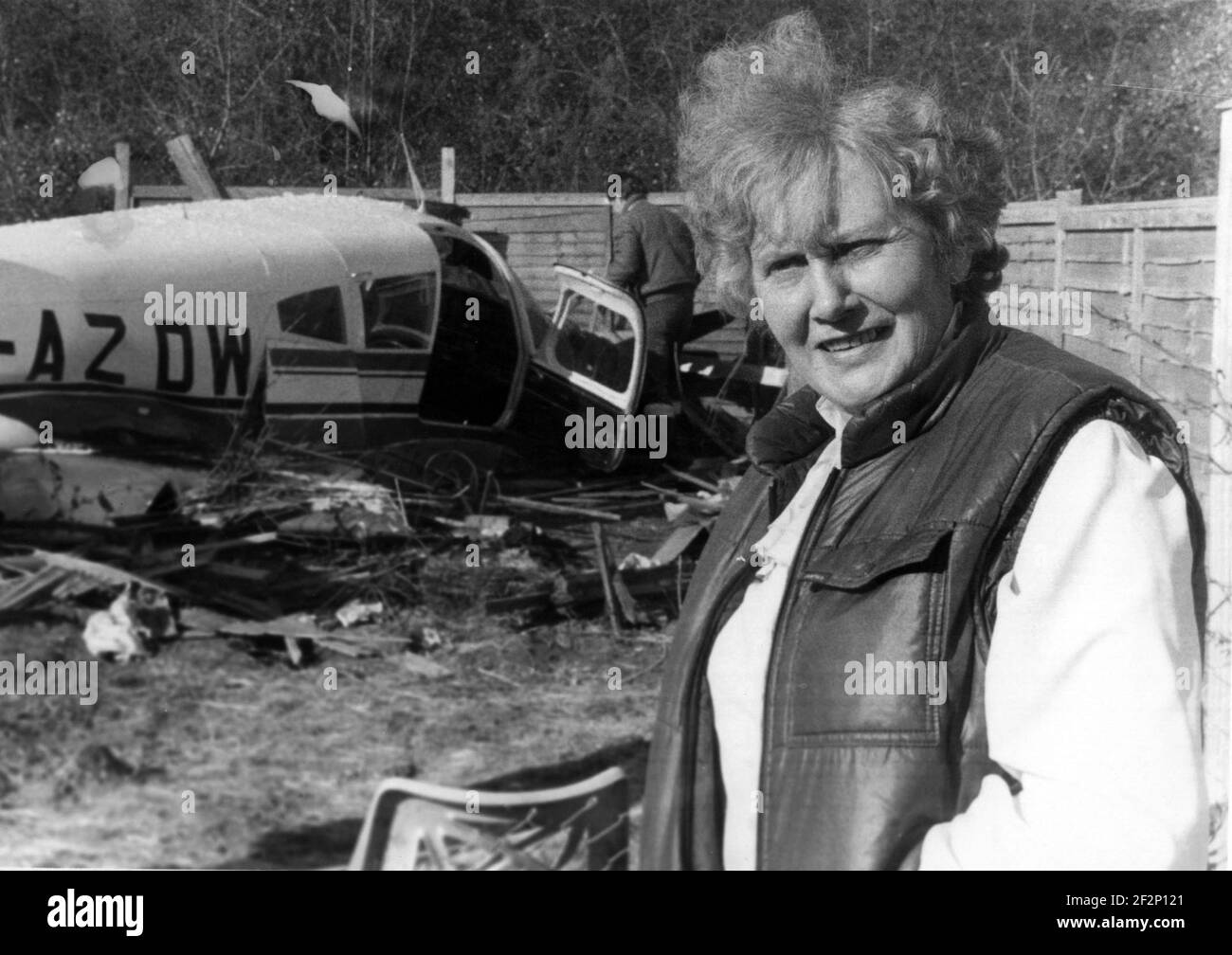 MRS DAPHNE GILBERT WITH THE WRECKAGE OF THE PLANE WHICH CRASHED IN HER ...