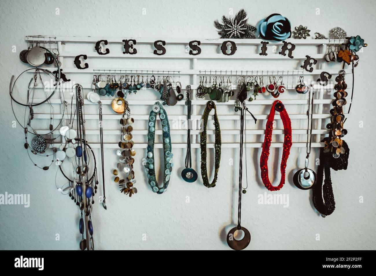 Accessories Jewellery, necklaces and earrings hang on the wall Stock ...