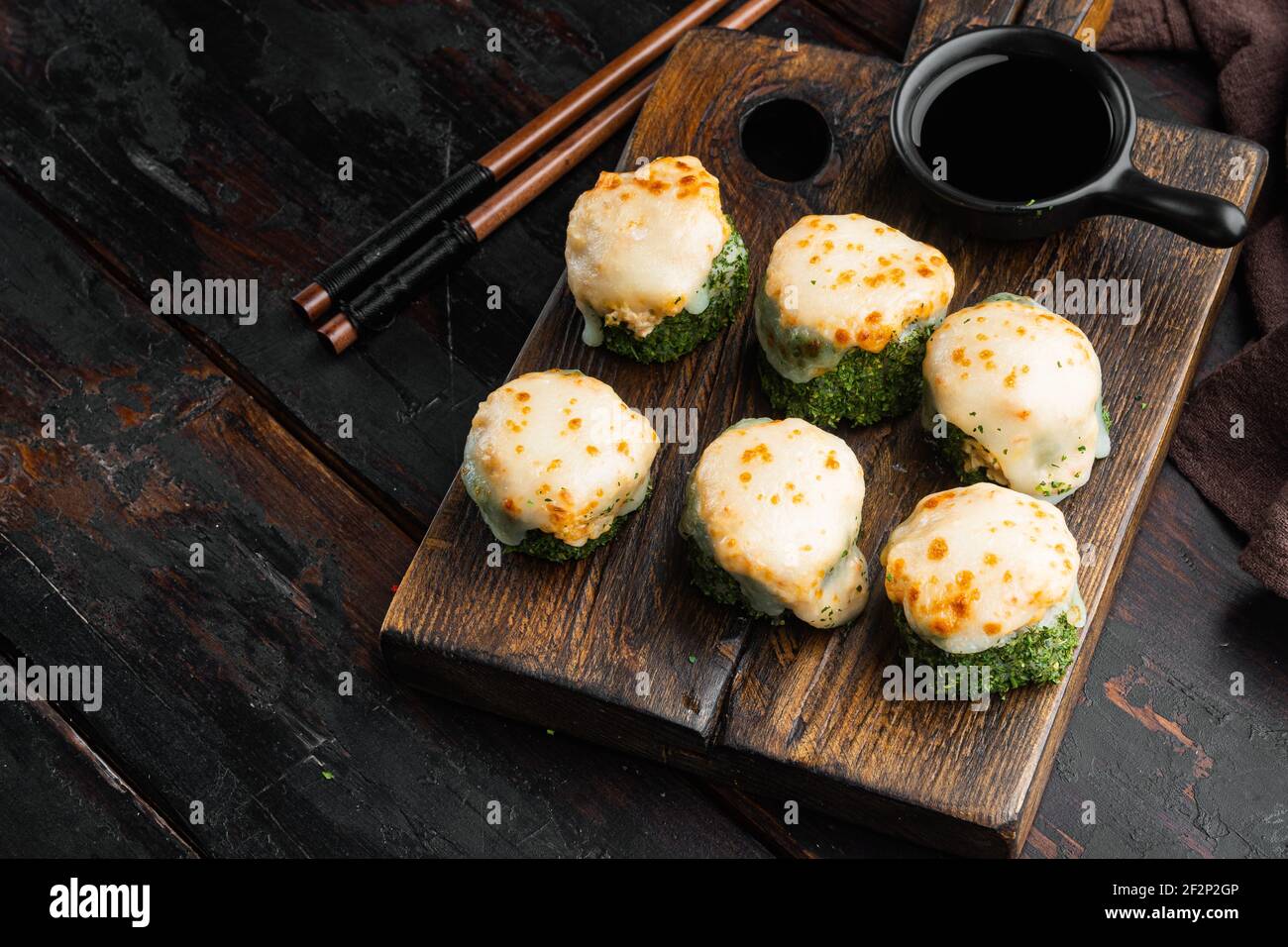 Baked sushi roll with shrimp and masago caviar cap. Traditional sushi ...