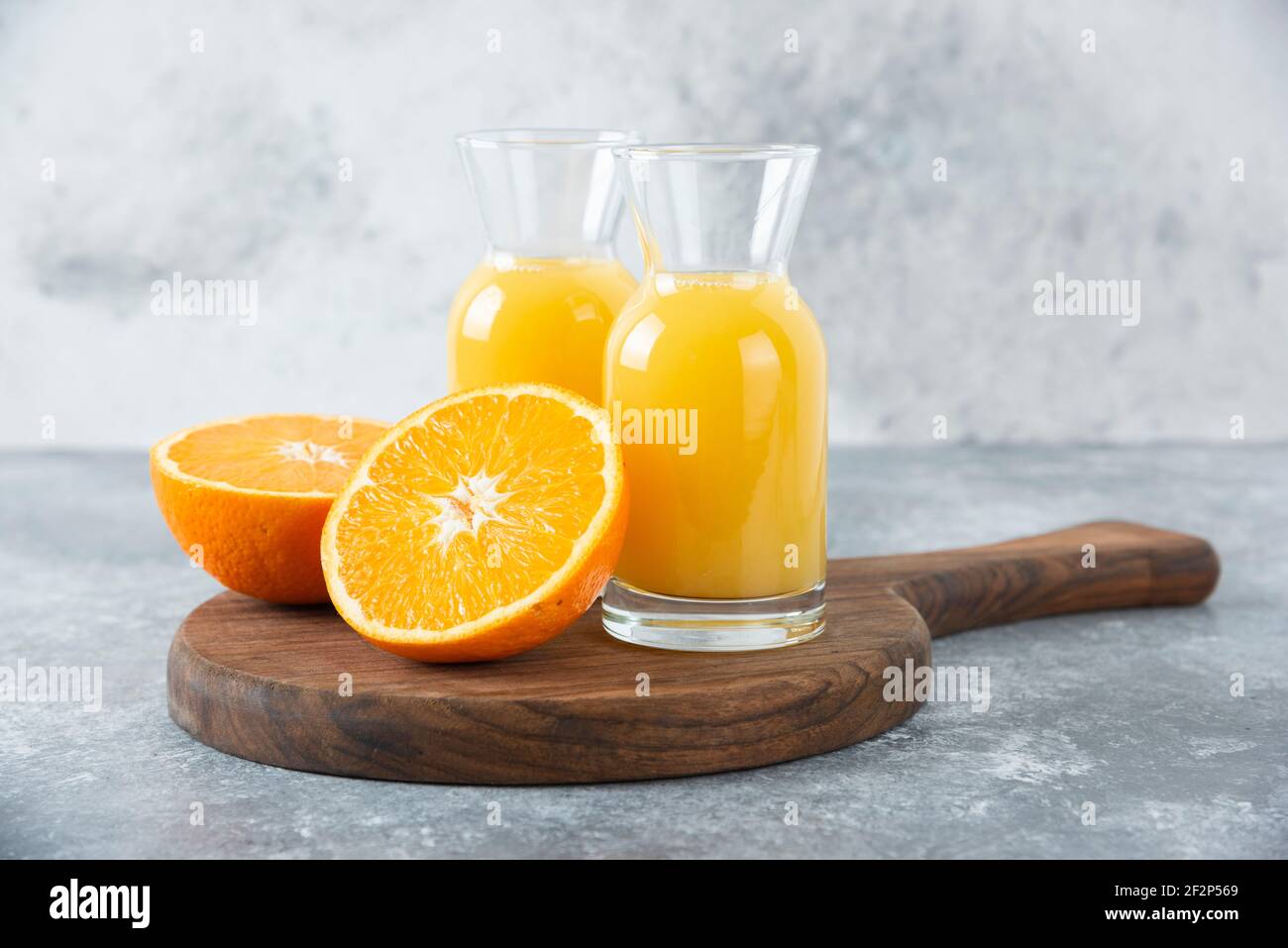 Glass pitchers of juice with slice of orange fruit Stock Photo - Alamy