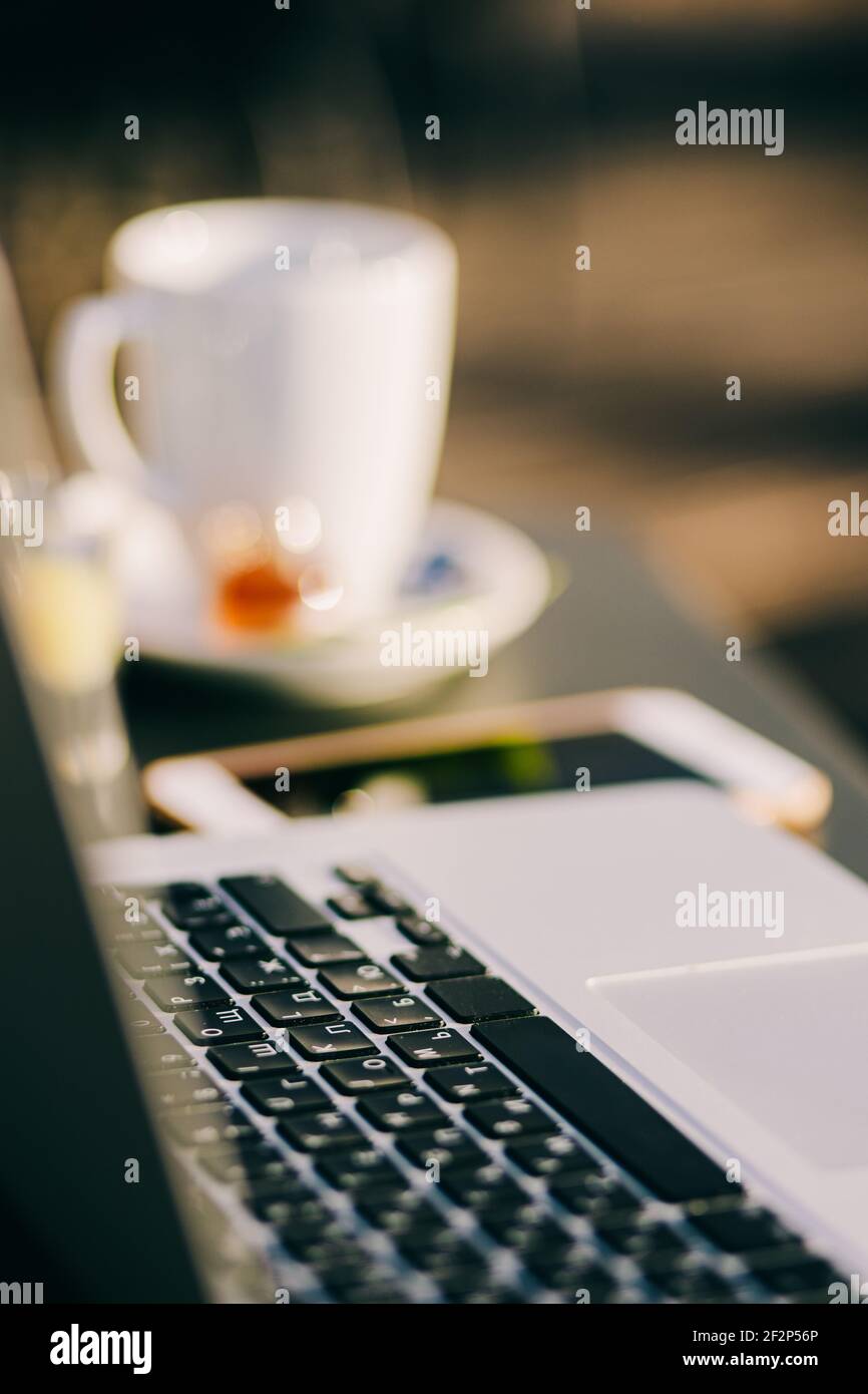 laptop and coffee cup with smartphone background Stock Photo - Alamy