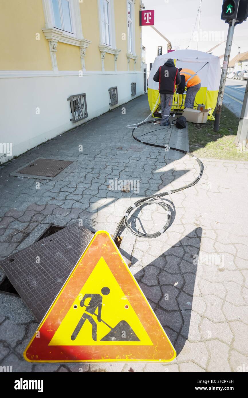 Workers run fiber optic cables for high-speed internet and better ...