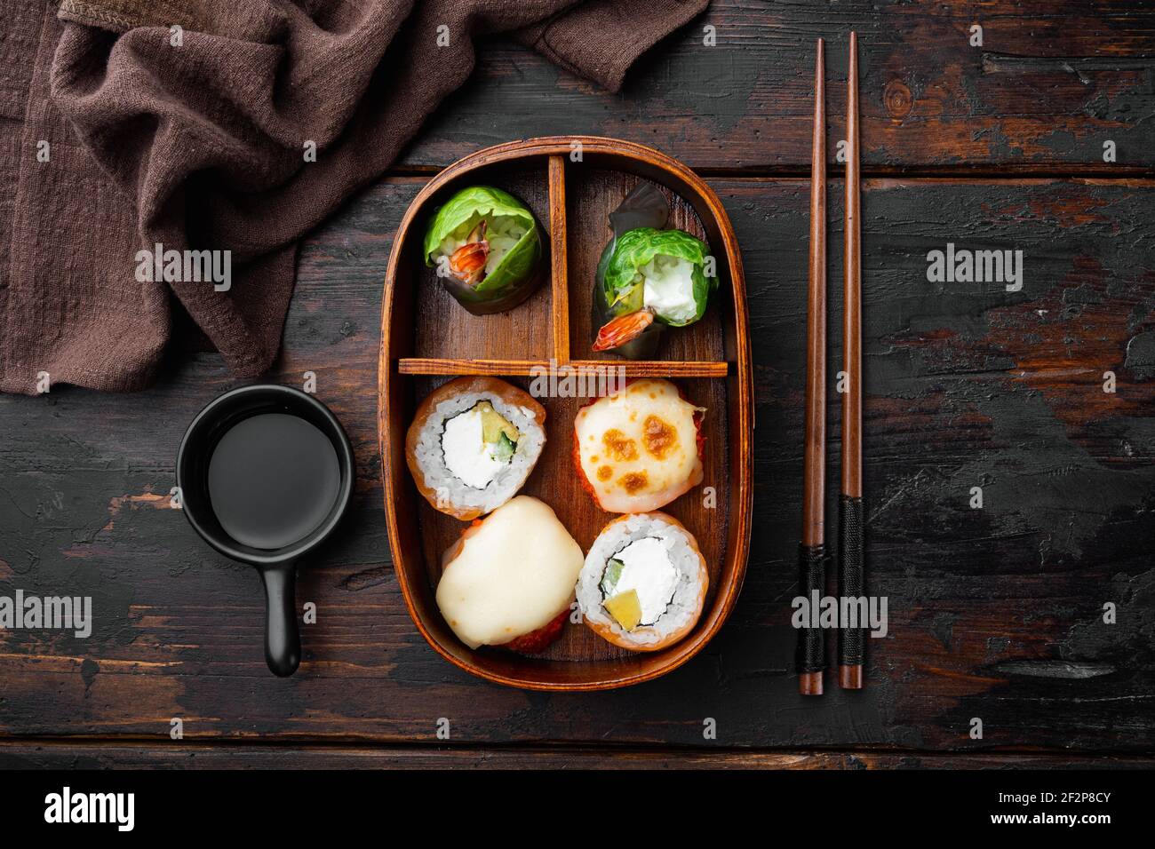 Homemade Sushi Bento Box with Sushi Rolls set, on old dark wooden table ...