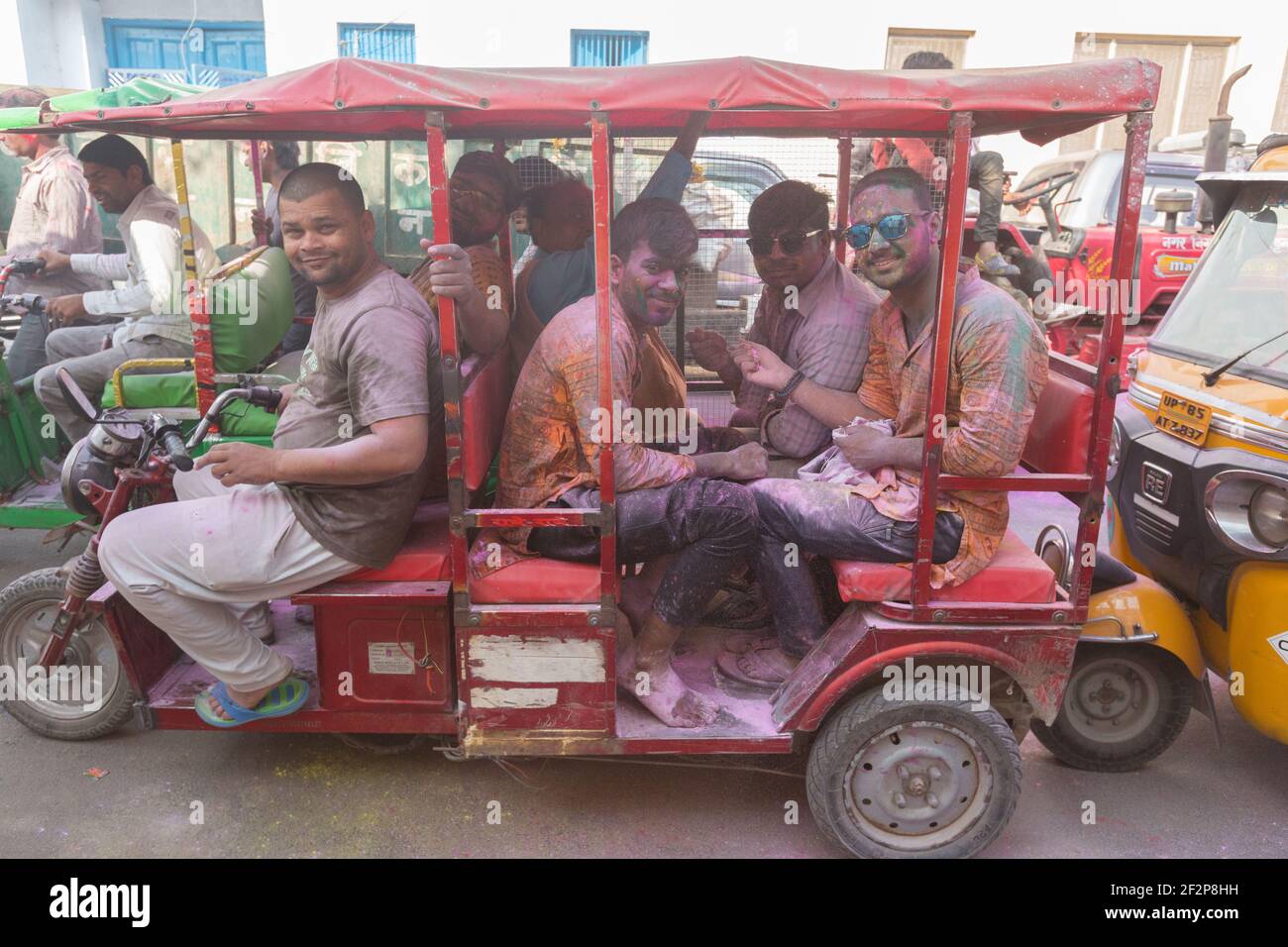 India Vrindavan Men riding tuk tuk after Holi festivities in Vrindavan ...