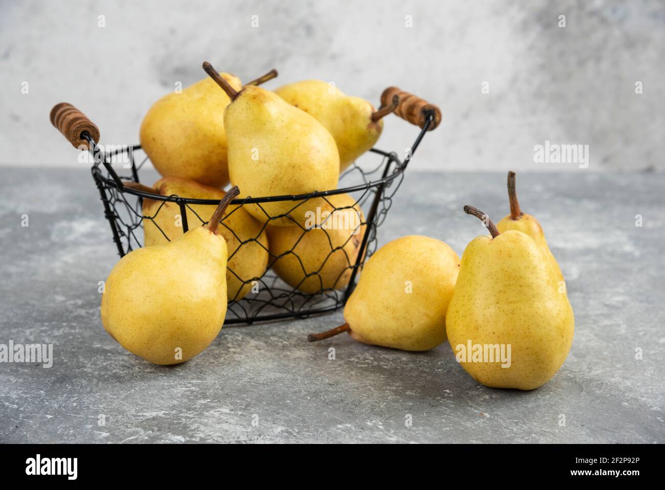 Bunch of fresh yellow pears in metal bucket on marble surface Stock ...