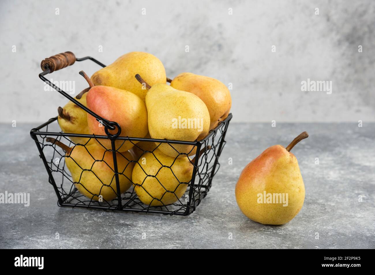 Pile of fresh yellow pears in metal bucket on marble surface Stock ...