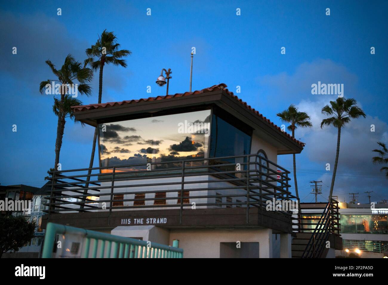 Sunset reflected in the window of lifeguard tower at Manhattan Beach ...