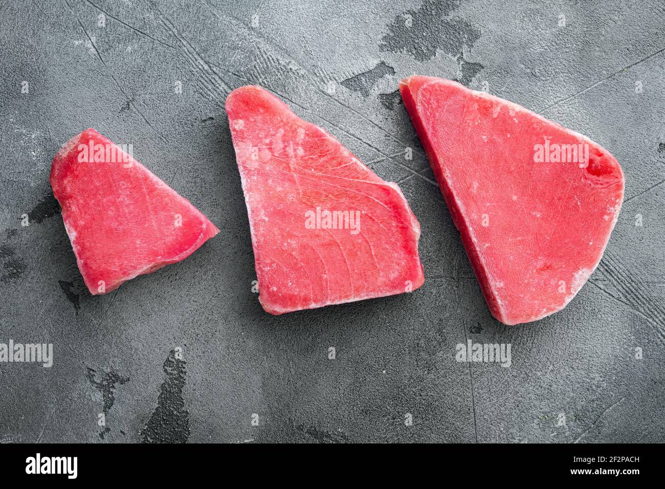 Raw frozen tuna fish fillet set, on gray stone background, top view ...