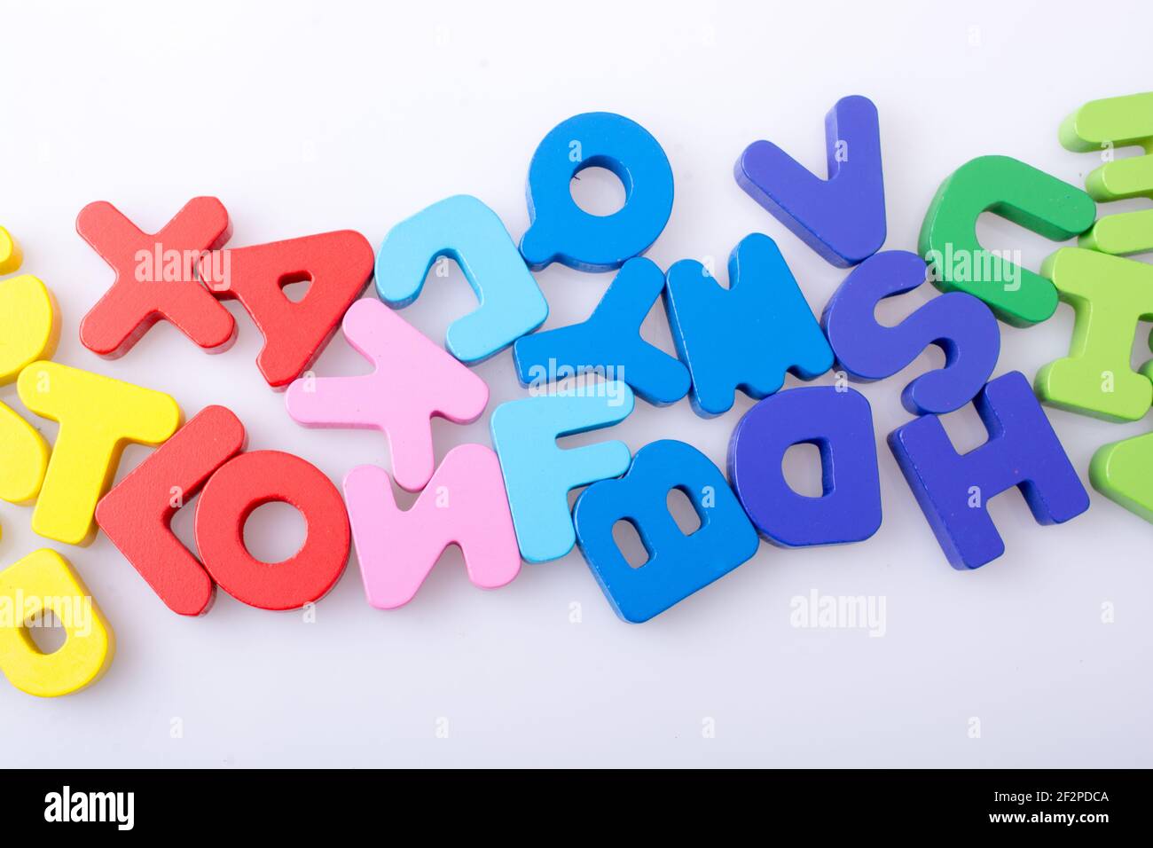 Colorful alphabet letter blocks scattered randomly on white background ...