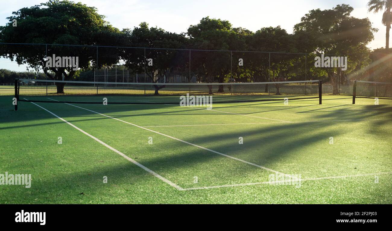 The early morning sun shines on a tennis court Stock Photo - Alamy