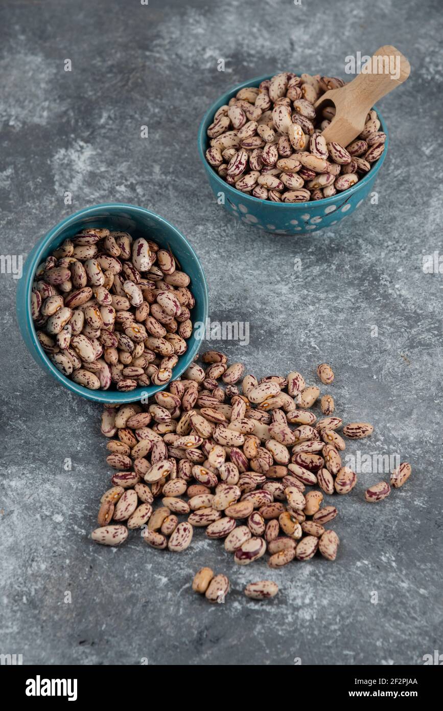 Raw bean grains displayed in bowls on marble surface Stock Photo - Alamy