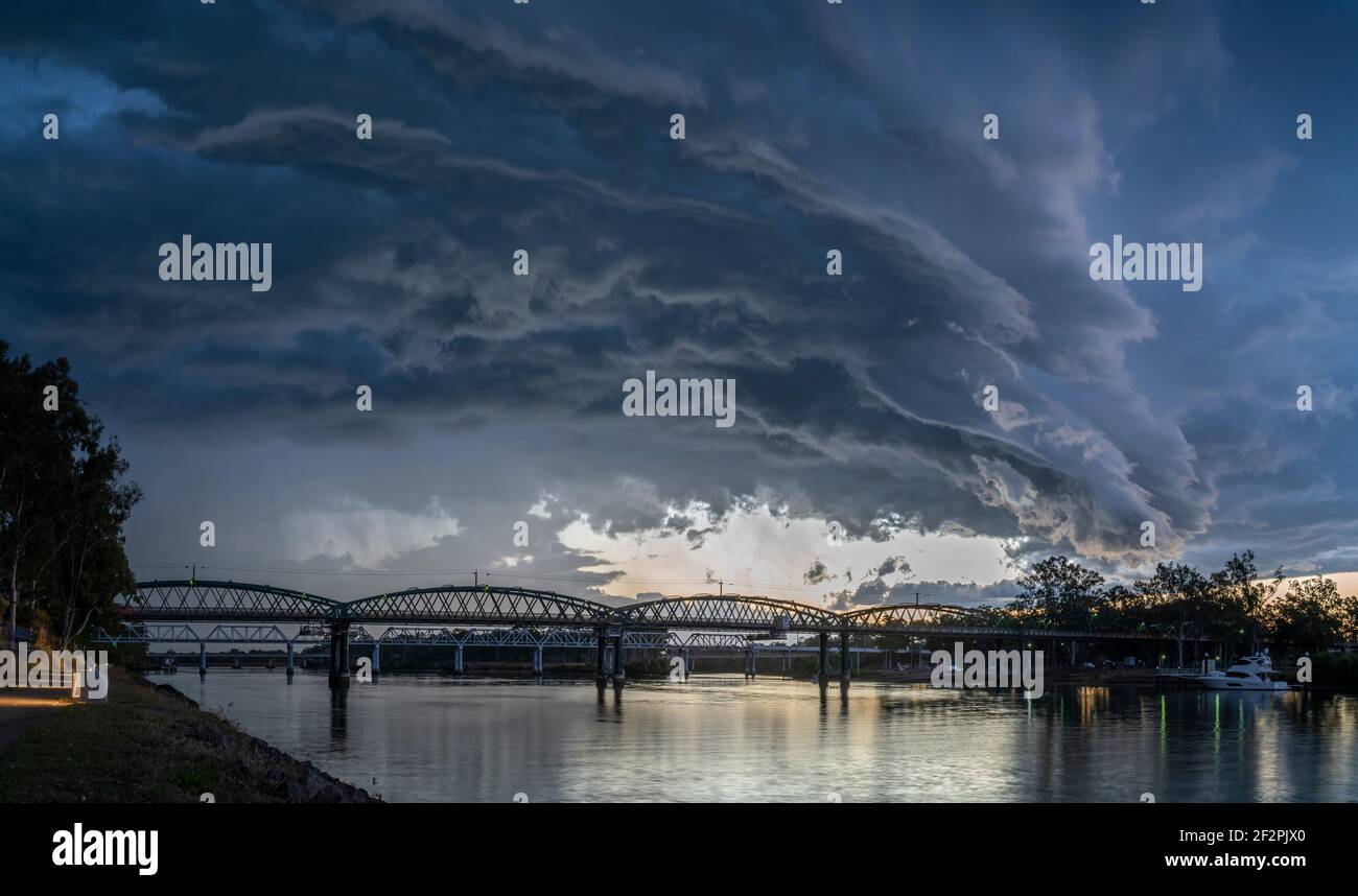 A storm front approaches the river Stock Photo - Alamy